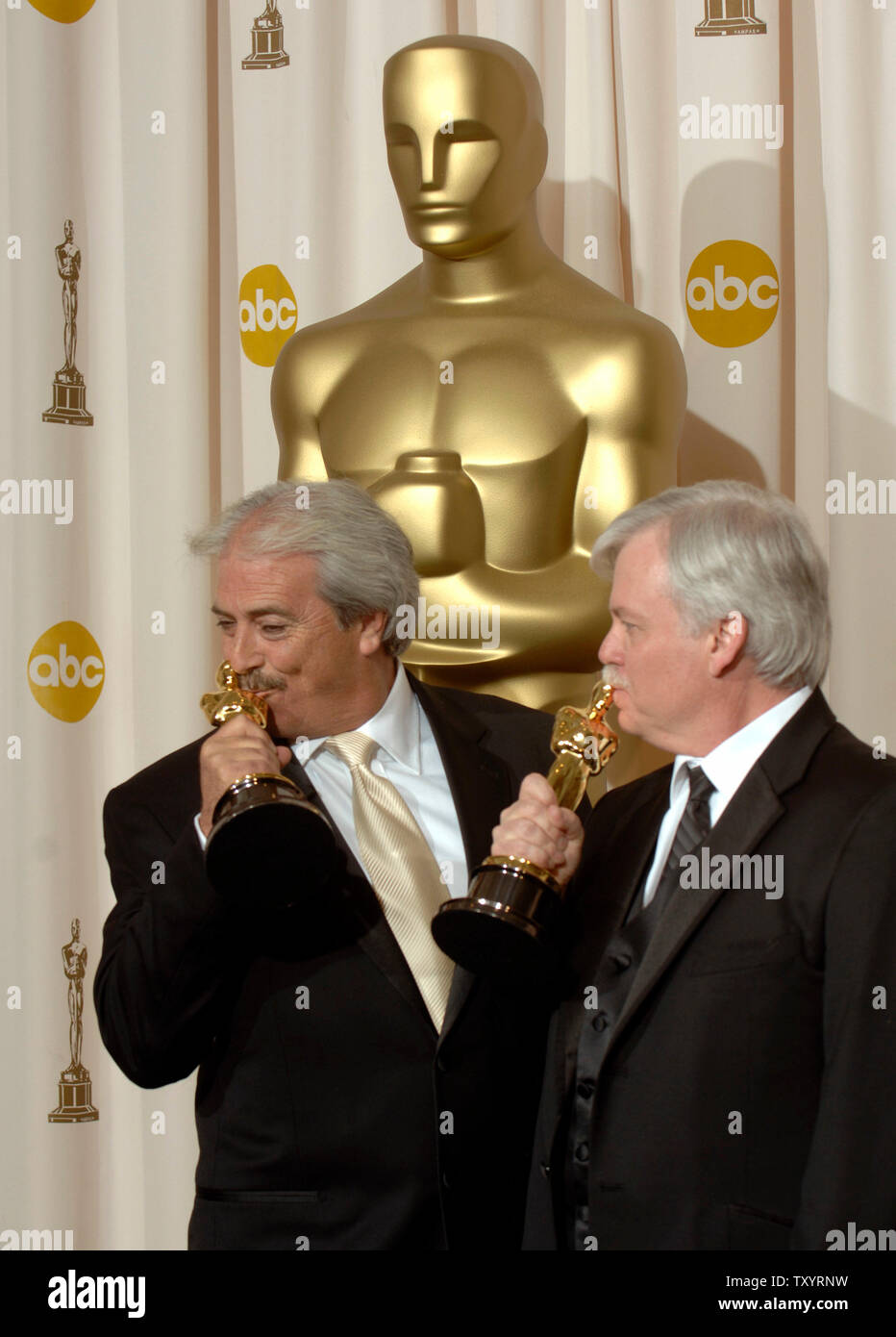 Alan Robert Murray and Bud Asman kiss their Oscars after winning for ...
