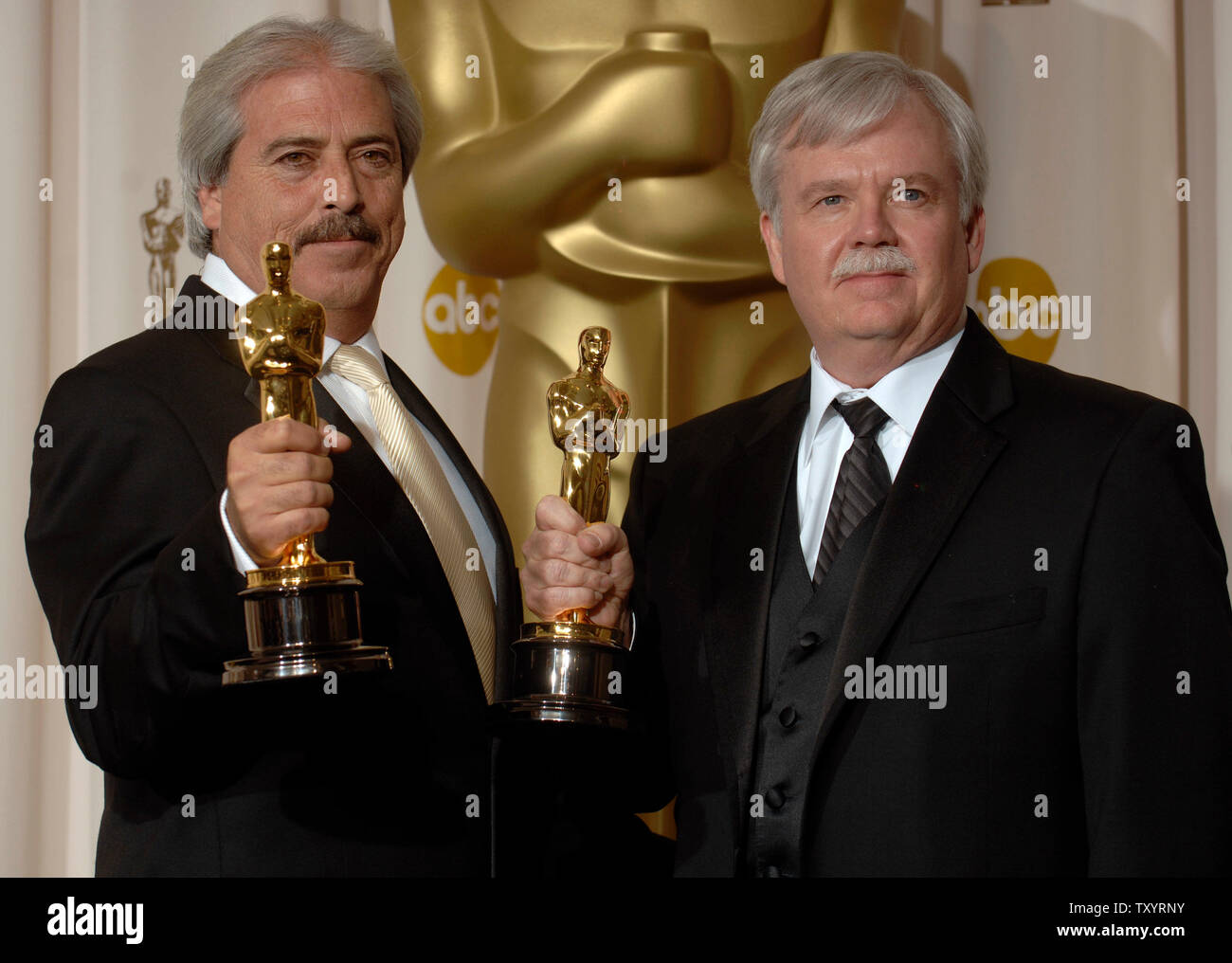 Alan Robert Murray and Bud Asman kiss their Oscars after winning for ...