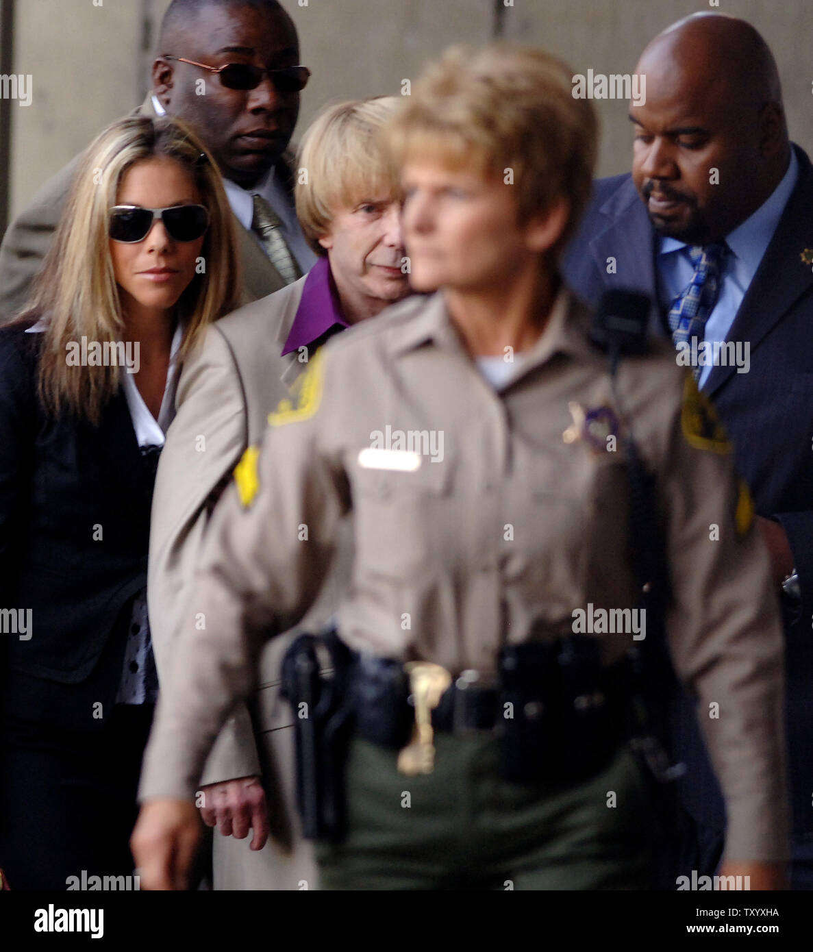 Music producer Phil Spector (C), accompanied by his wife, Rachelle ...
