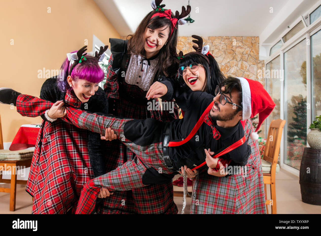 group of friends celebrating christmas spirit having fun with man Stock ...
