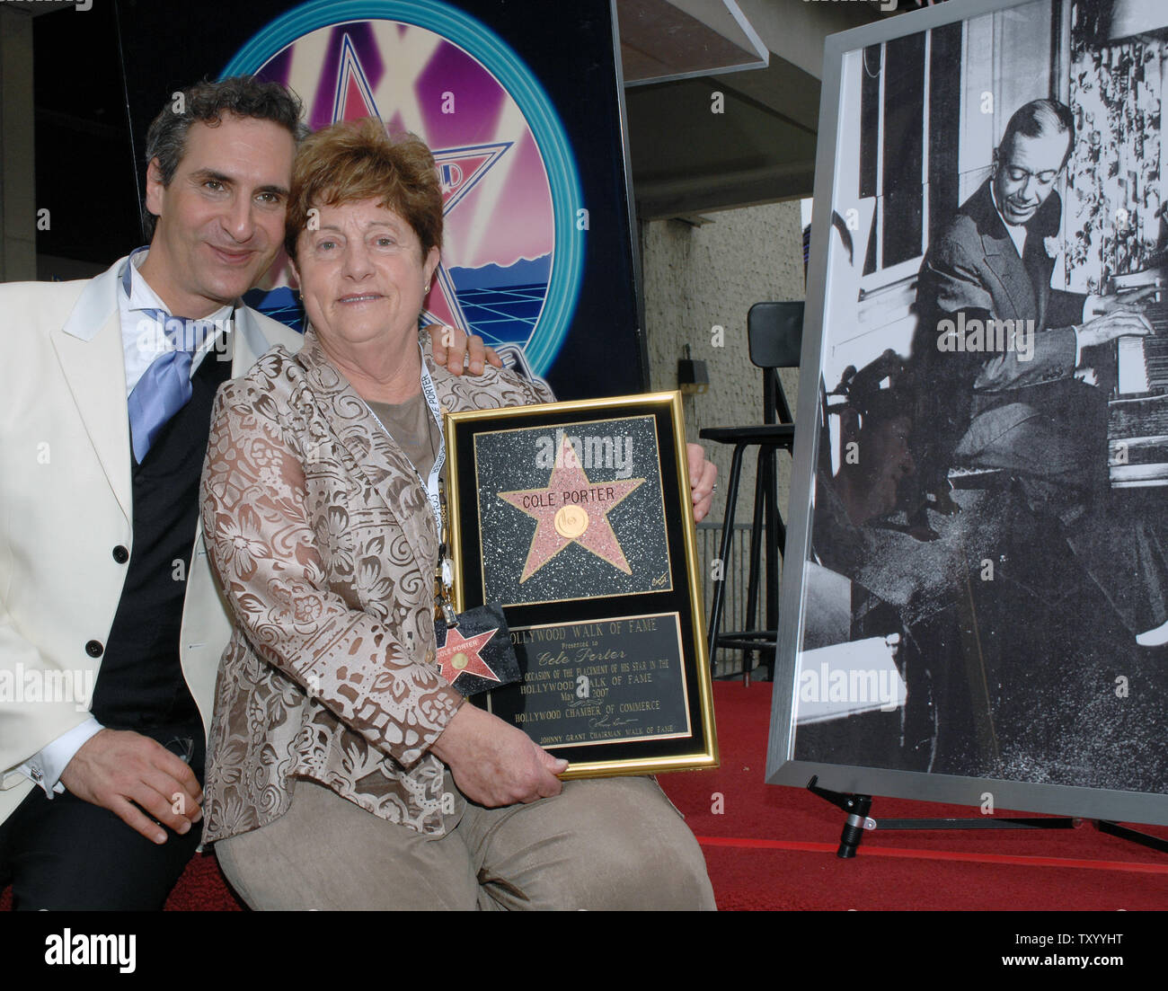 Family member Joey Cole Kubesh holds a replica plaque during an ...