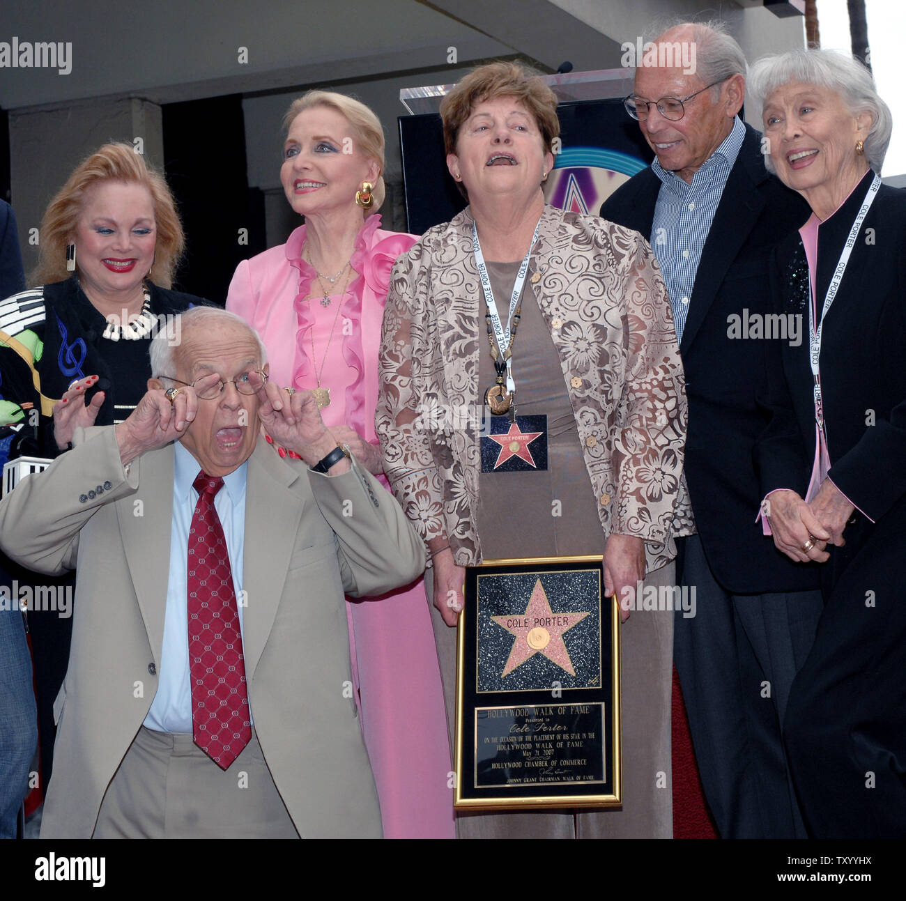 Family member Joey Cole Kubesh holds a replica plaque during an ...