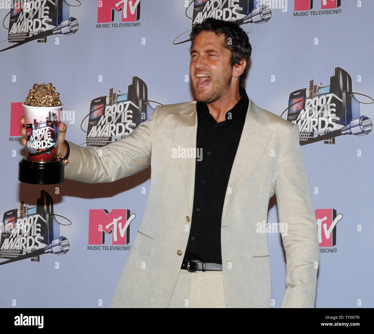 Actor Gerard Butler appears backstage with his award for best fight ...