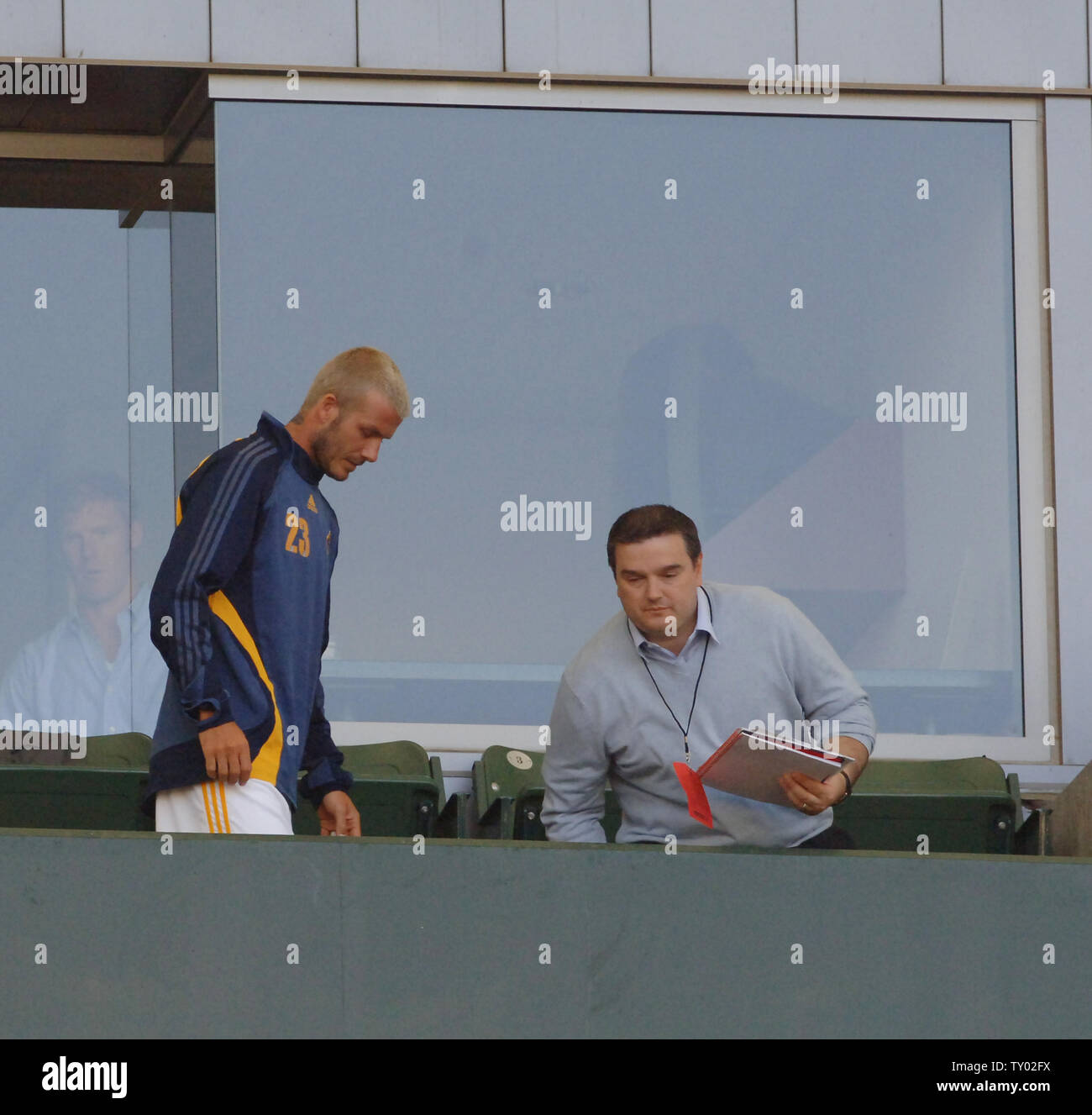 Los Angeles Galaxy's David Beckham (L) walks to a seat in a luxury box ...