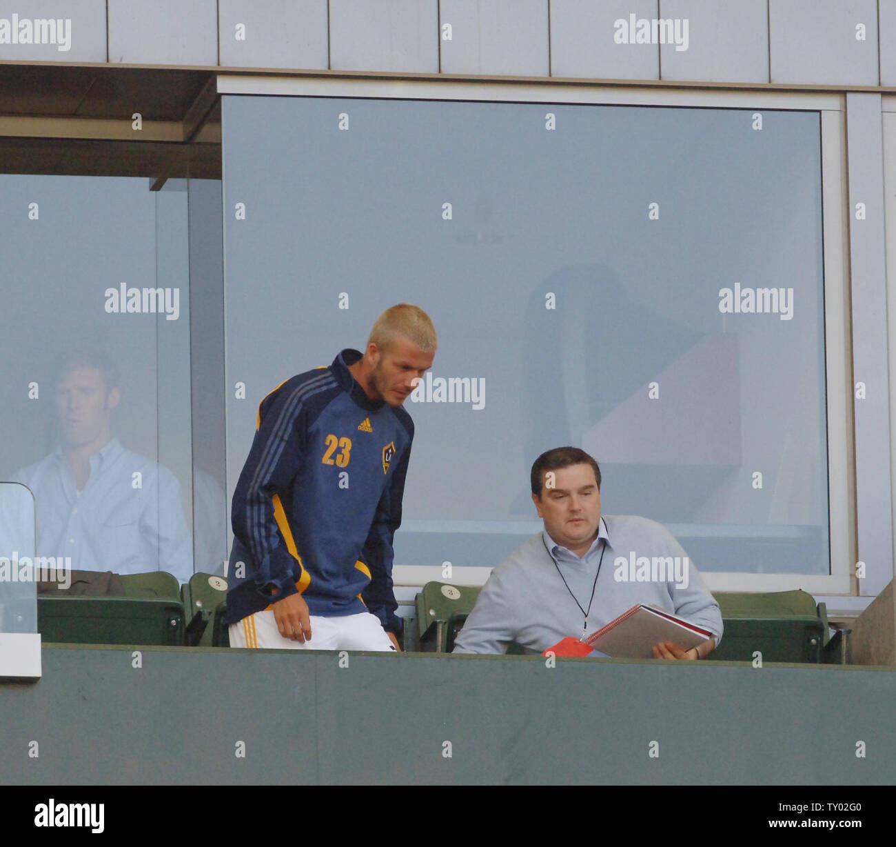 Los Angeles Galaxy's David Beckham (L) walks to a seat in a luxury box ...
