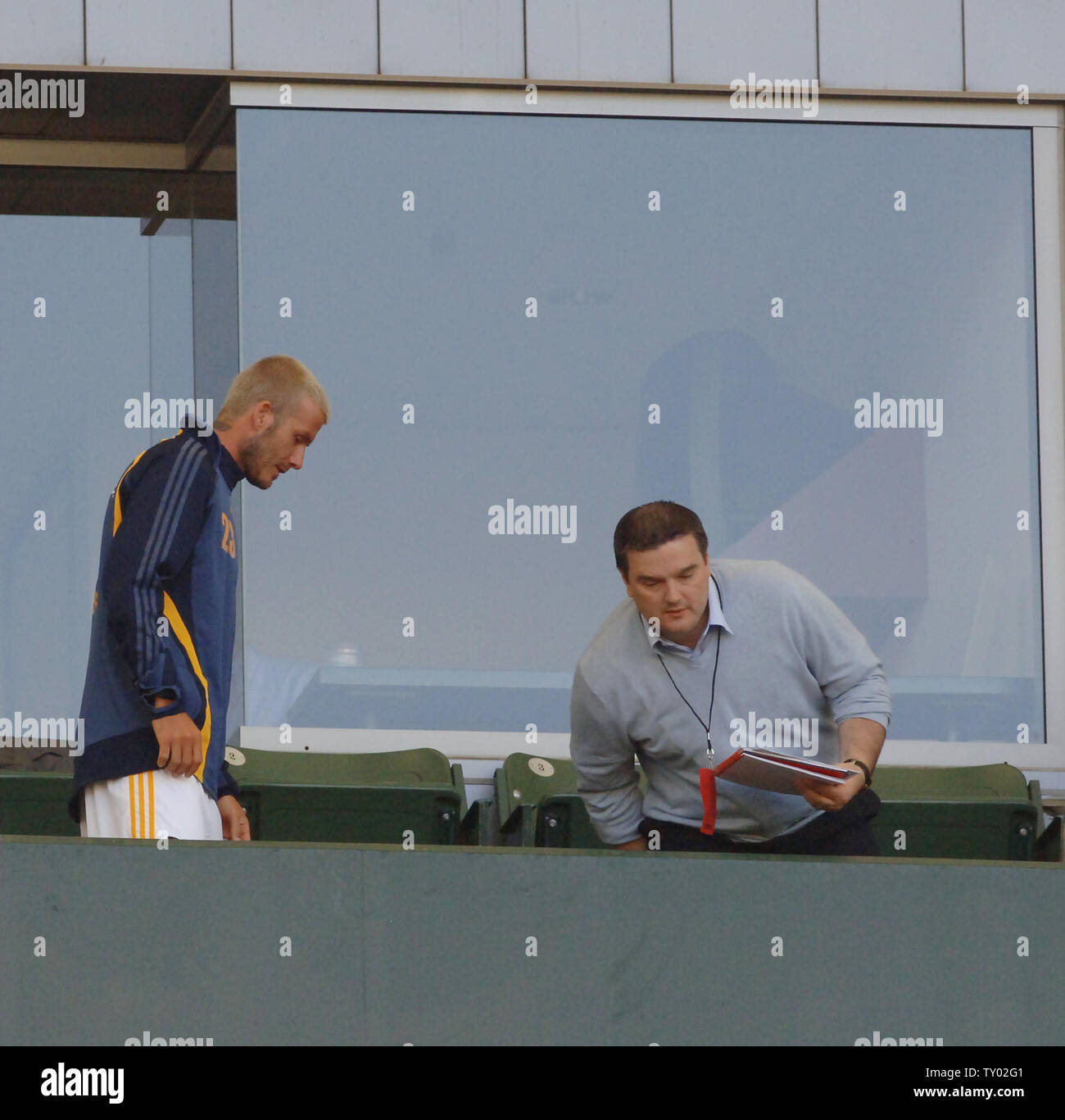 Los Angeles Galaxy's David Beckham (L) walks to a seat in a luxury box ...