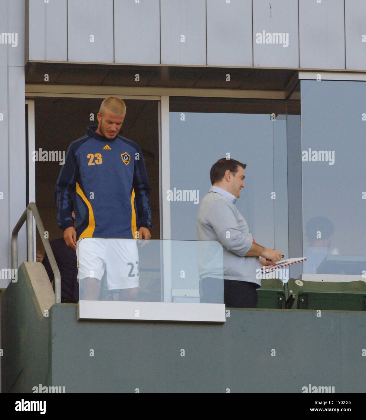 Los Angeles Galaxy's David Beckham (L) walks to a seat in a luxury box ...