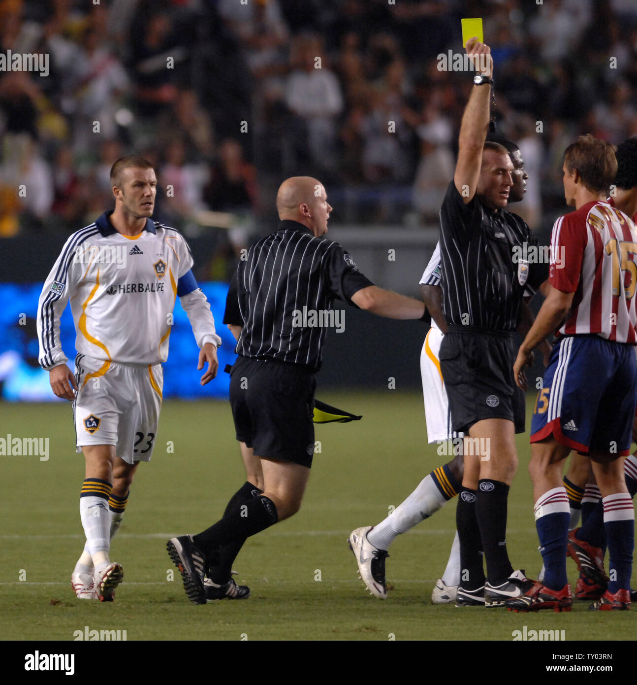 Los Angeles Galaxy's captain David Beckham (23) is held back by referee ...