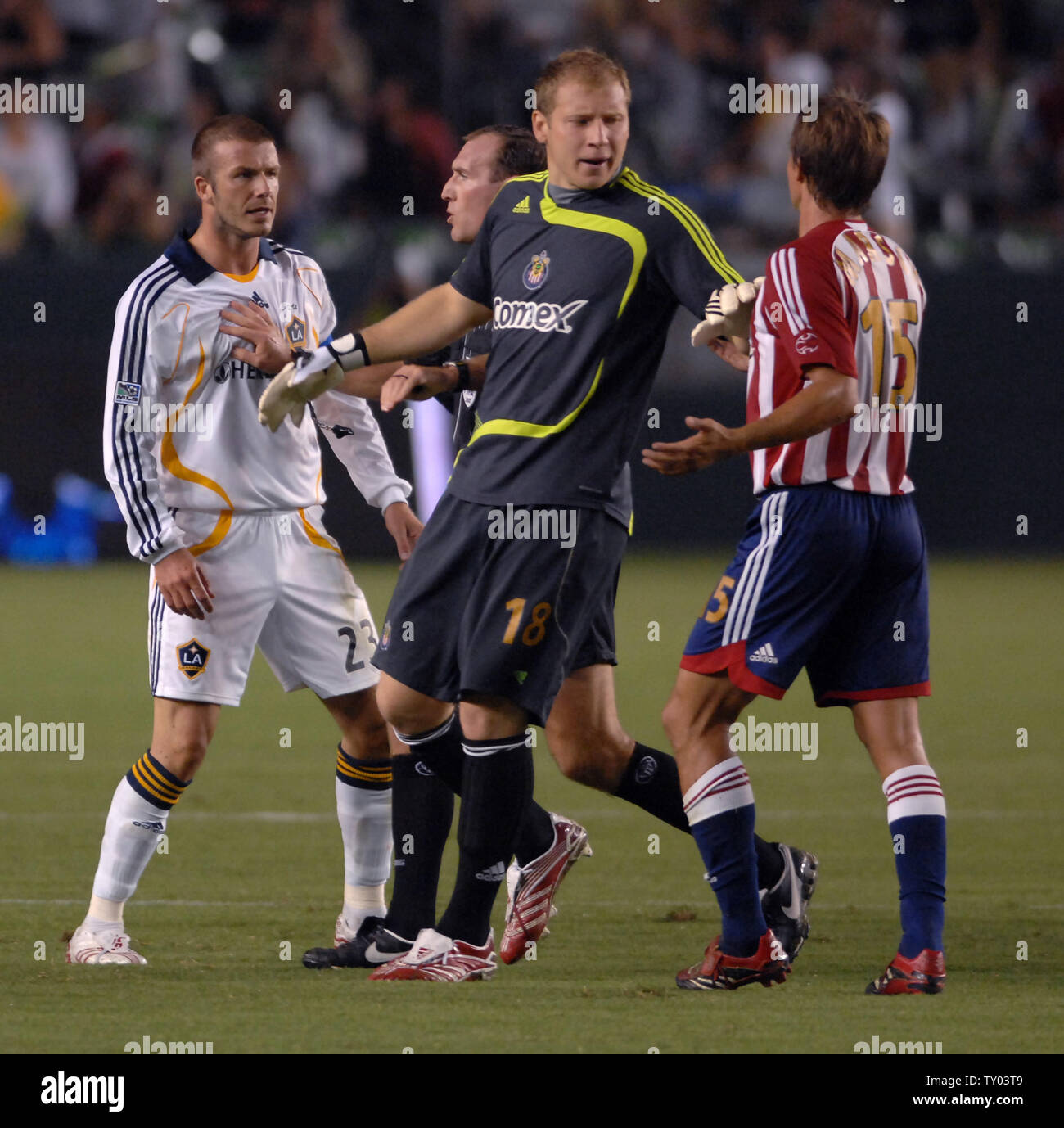 Los Angeles Galaxy's captain David Beckham (23) is held back by referee ...