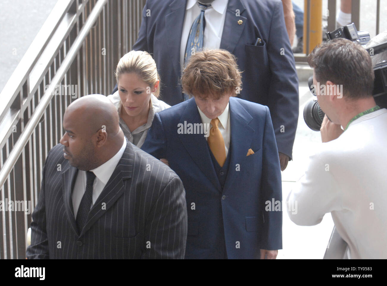 Phil Spector (R) leaves with wife Rachelle Spector and unidentified ...