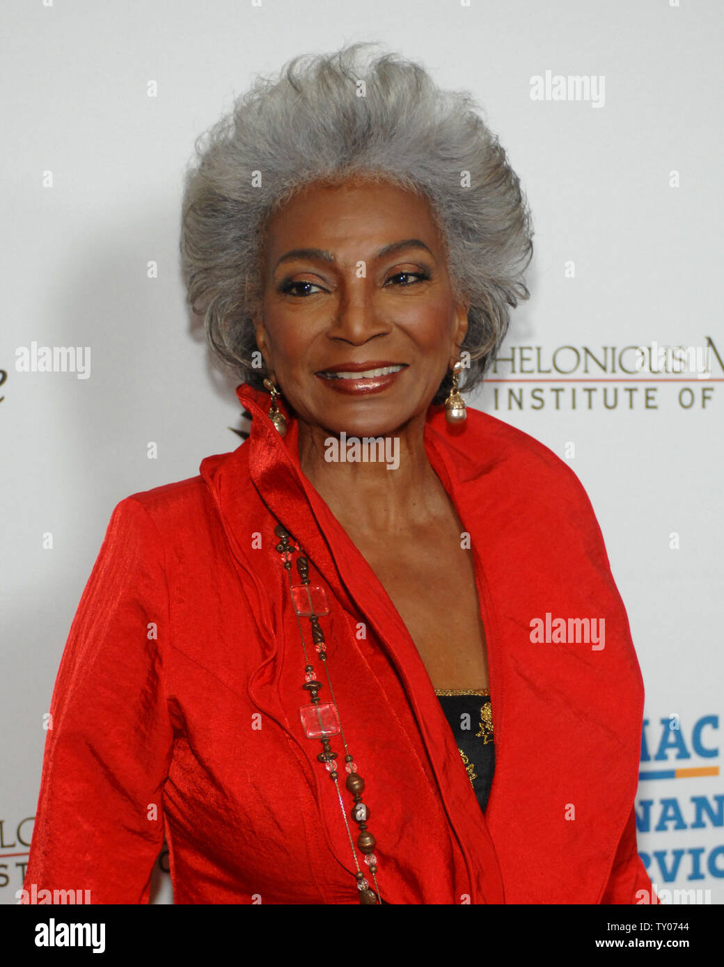 Actress Michele Nicholson smiles for photographers after she arrives on ...