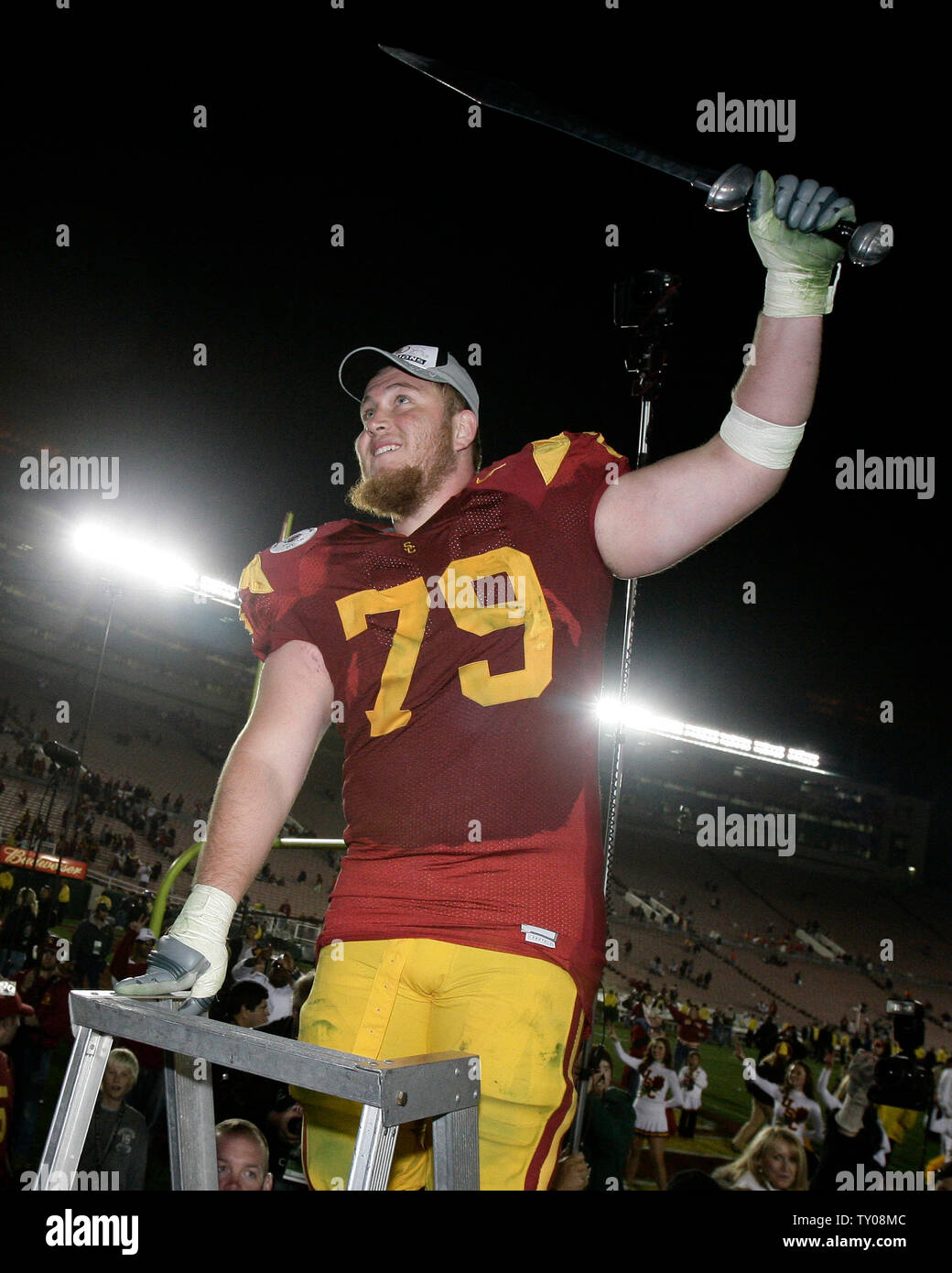 USC Trojans senior offensive lineman Sam Baker leads the band post game ...