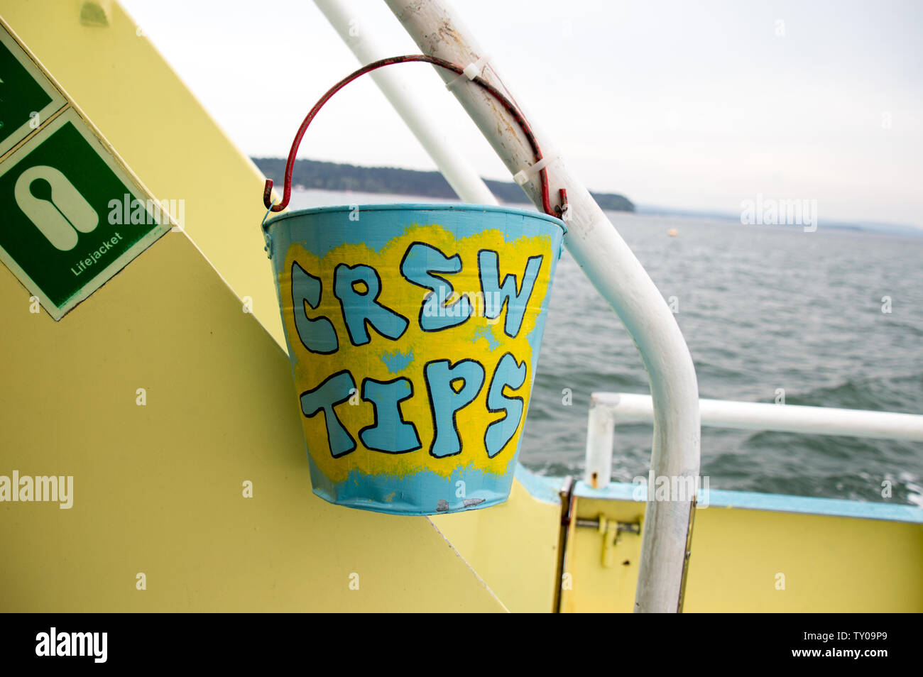 Crew tips bucket hanging in a boat Stock Photo - Alamy
