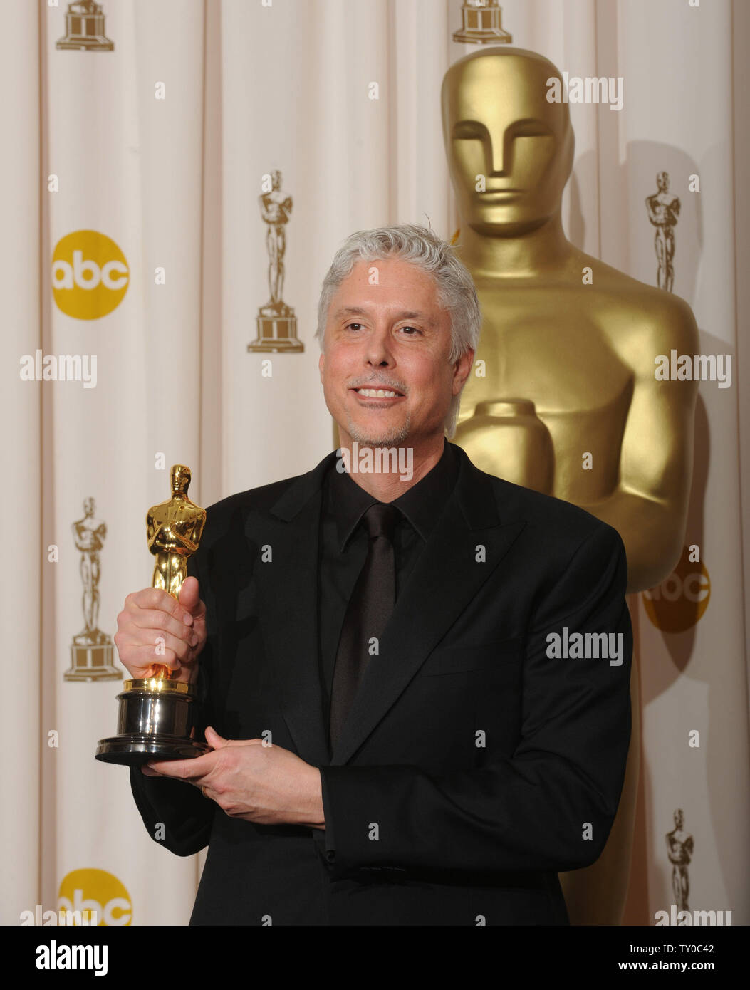 Christopher Rouse poses with his Oscar for Achievement in Film Editing ...