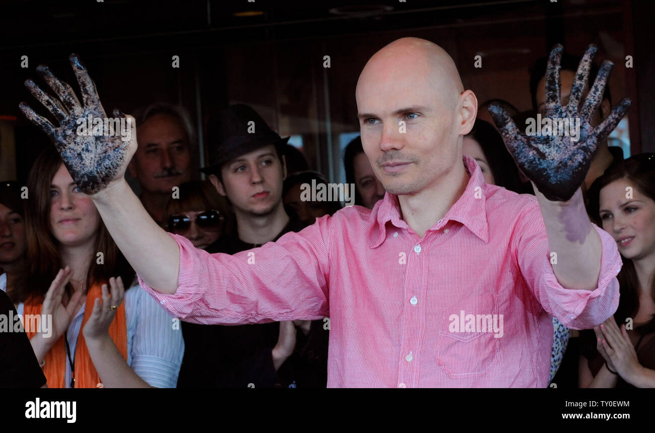 Billy Corgan of rock band The Smashing Pumpkins holds up his hands ...