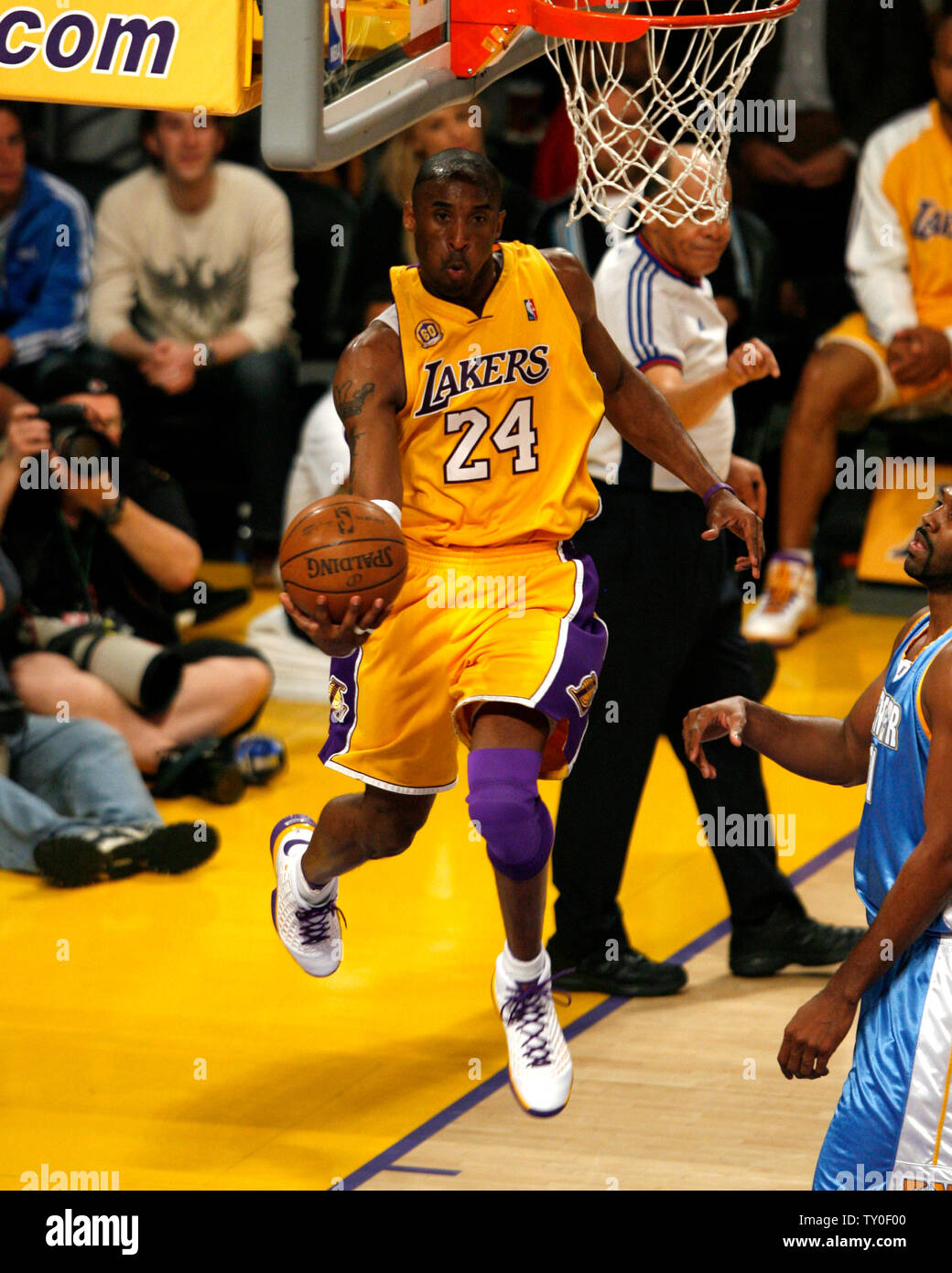 Los Angeles Lakers' Kobe Bryant does a reverse lay up by Denver Nuggets ...