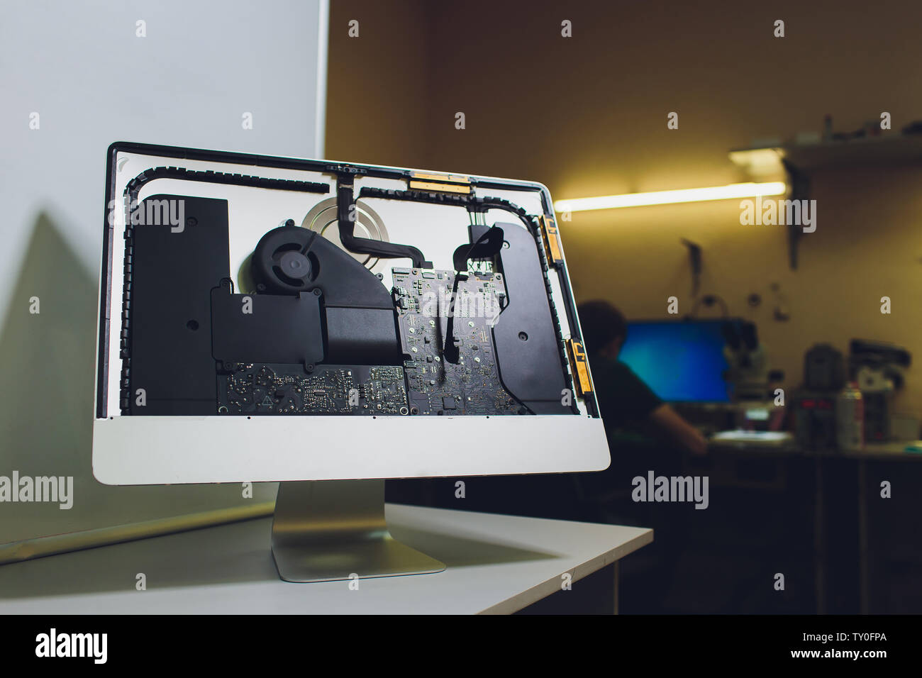 Process of computer repair. Engineer in white gloves disassembling ...