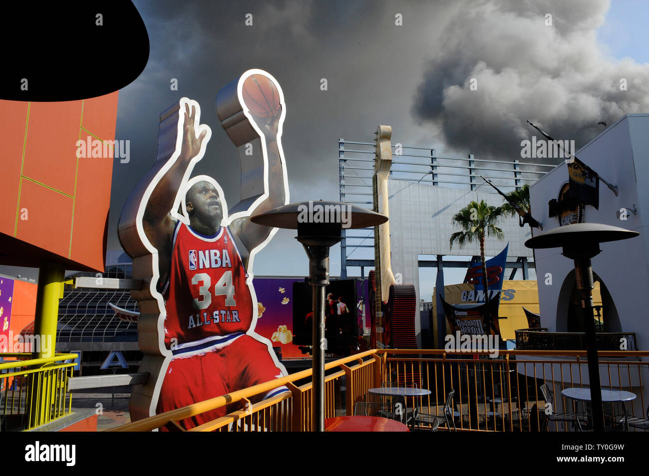 Smoke billows over Universal Walk as a fire rages out of control on the ...
