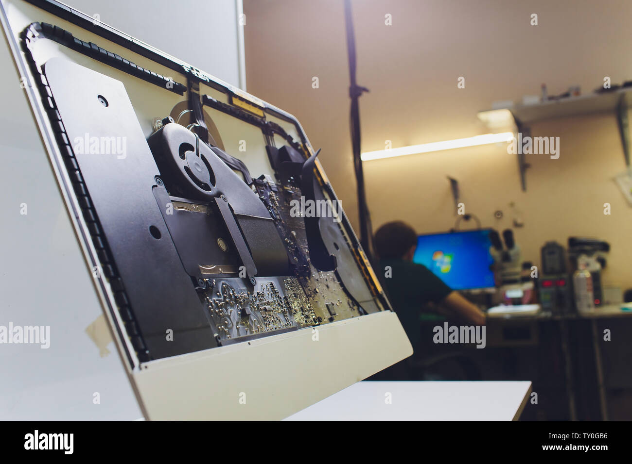 Process of computer repair. Engineer in white gloves disassembling ...