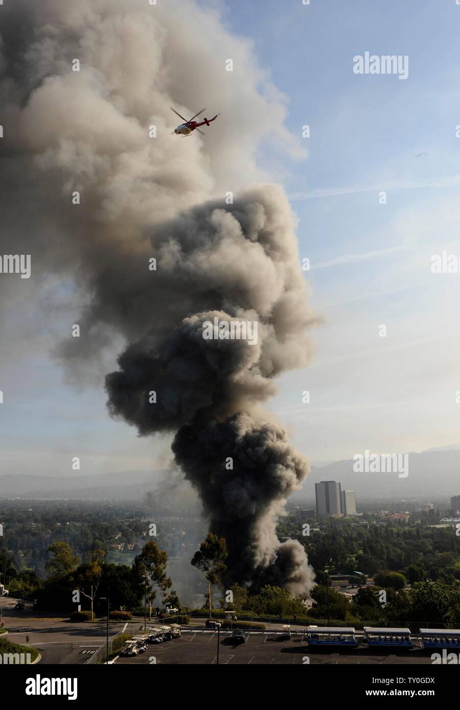 A fire rages out of control on the backlot filled with movie sets at ...