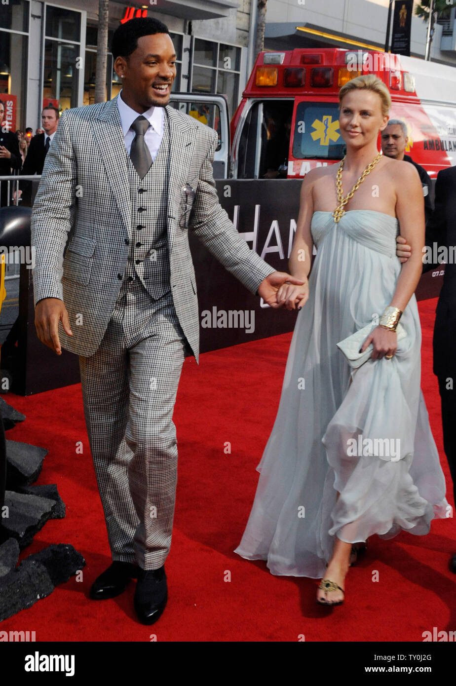 Will Smith (L) and Charlize Theron, cast members in the motion picture ...
