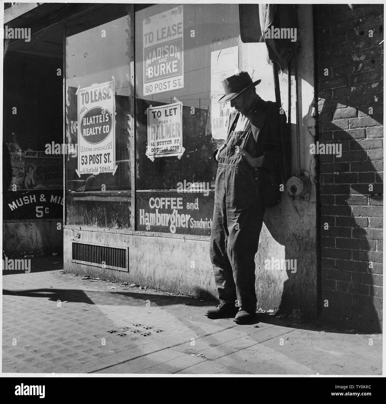 Depression: Unemployed;destitute man leaning against vacant store:photo ...