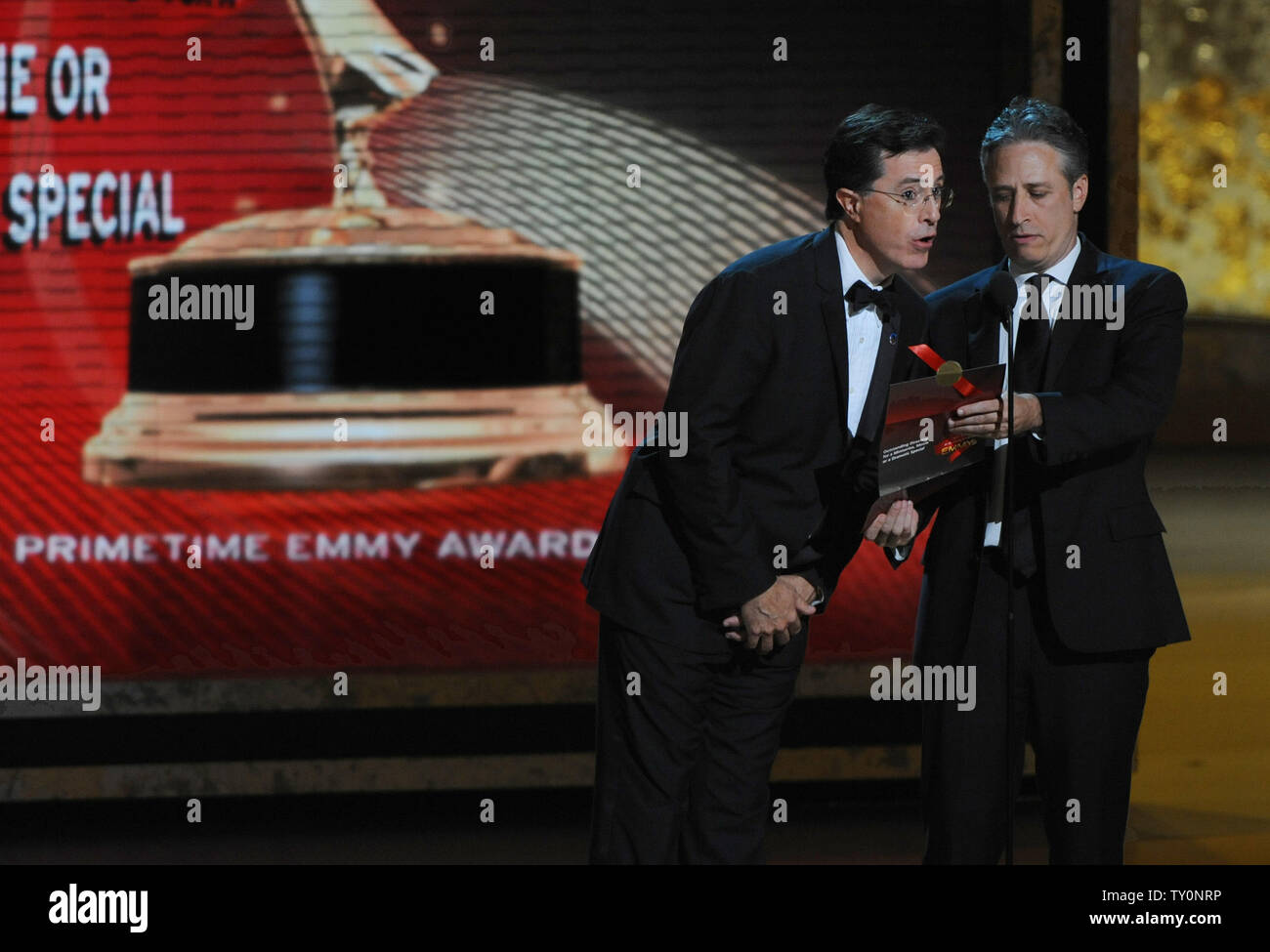 Stephen Colbert (L) and Jon Stewart present an award at the 60th annual ...