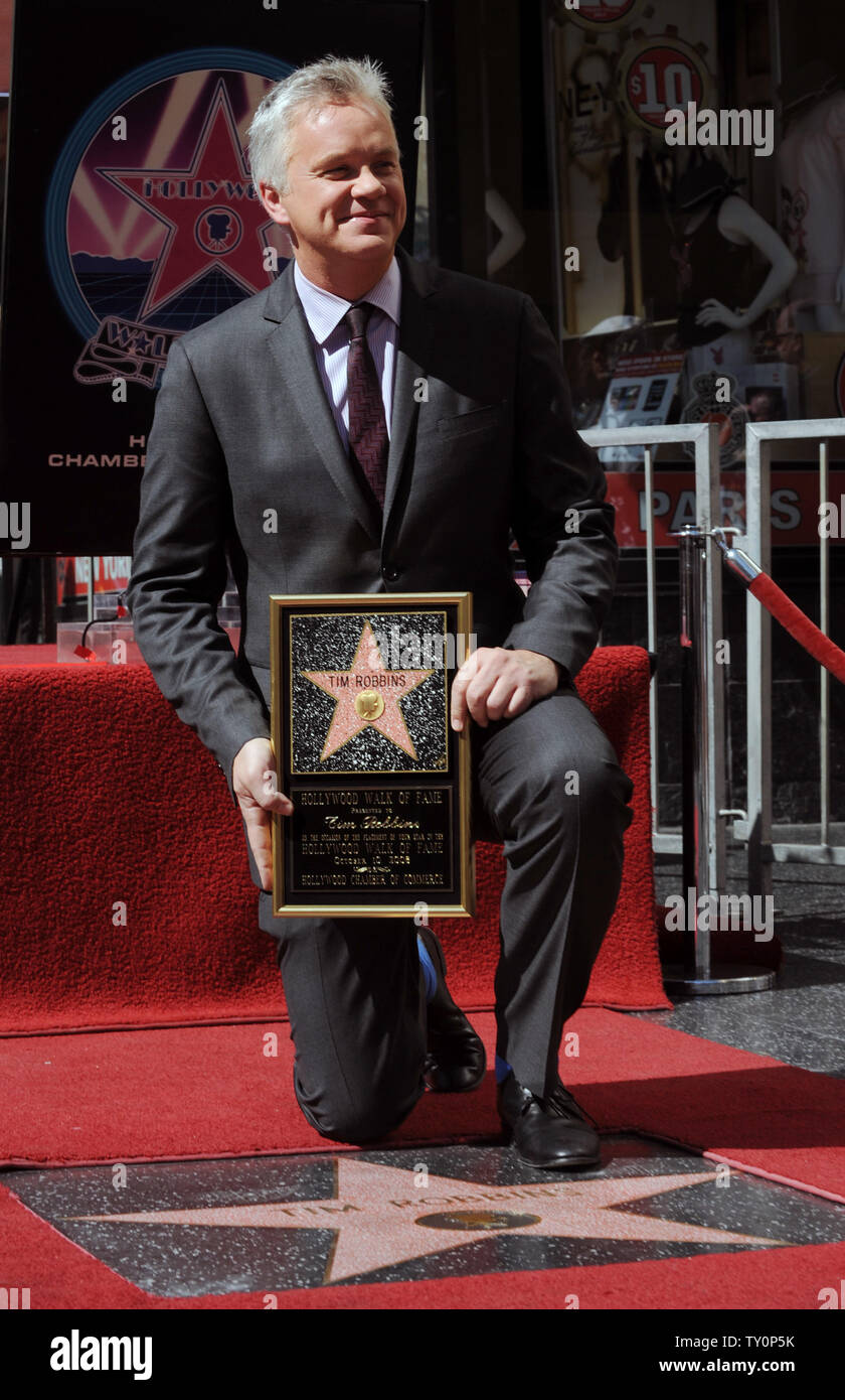 U.S. actor Tim Robbins holds a replica plaque during an unveiling ...