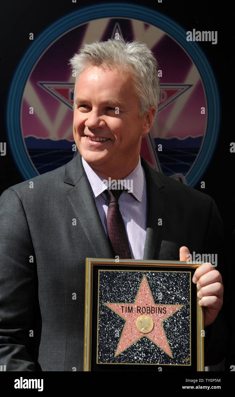 U.S. actor Tim Robbins holds a replica plaque during an unveiling ...