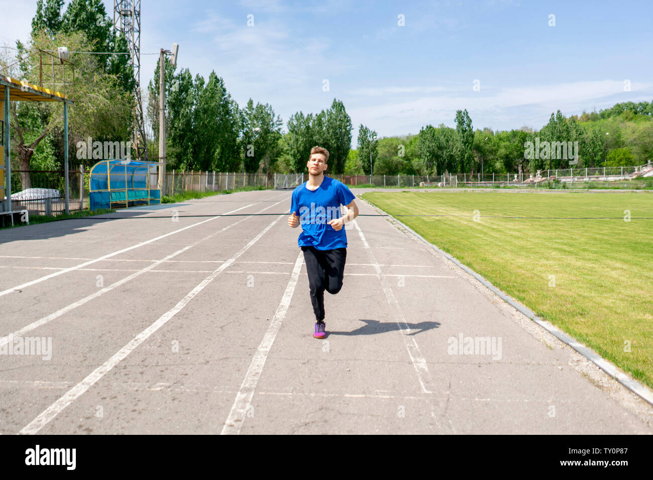 fast speed runner on the stadium sport track outdoor before the ...