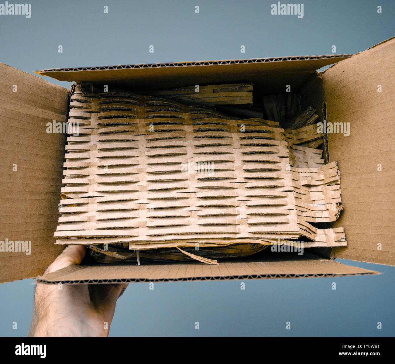Man hand holding empty cardboard box after before unboxing with ...