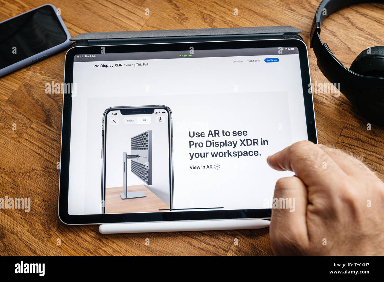 Paris, France - Jun 6, 2019: Man reading on Apple iPad Pro tablet about ...