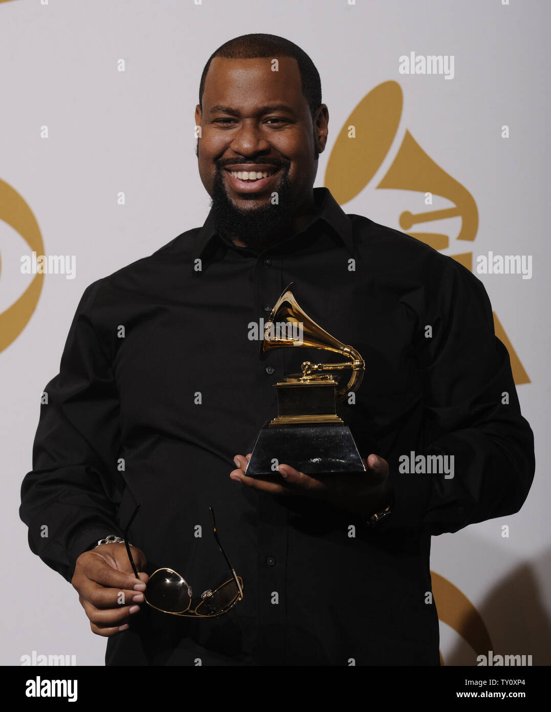 Darius "Deezle" Harrison holds his Grammy Award for Best Rap Song at ...