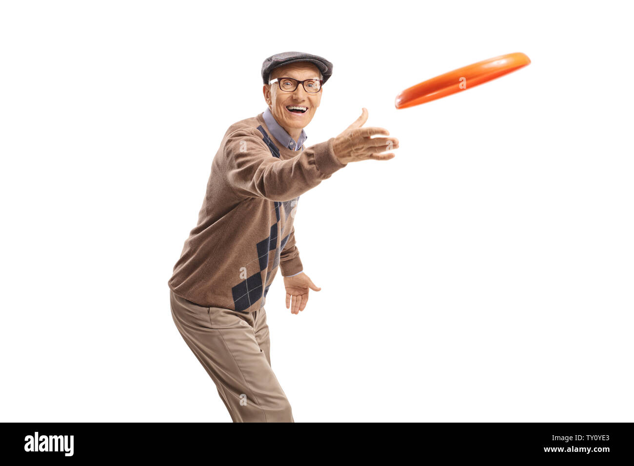 Cheerful elderly man playing with a frisbee isolated on white ...