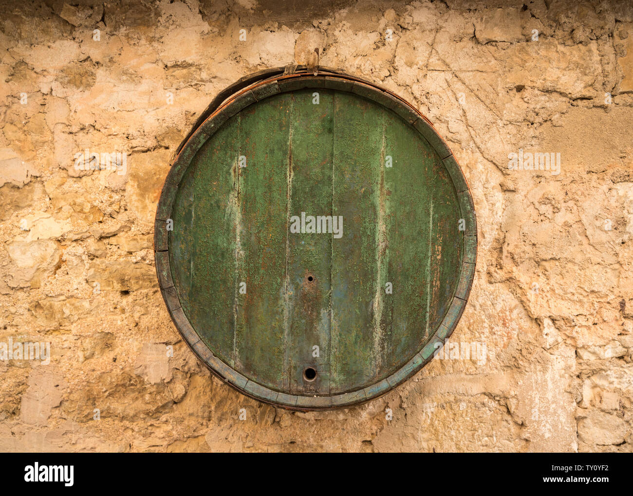 Wooden barrel hanging on old rustic stone wall of farmhouse Stock Photo ...