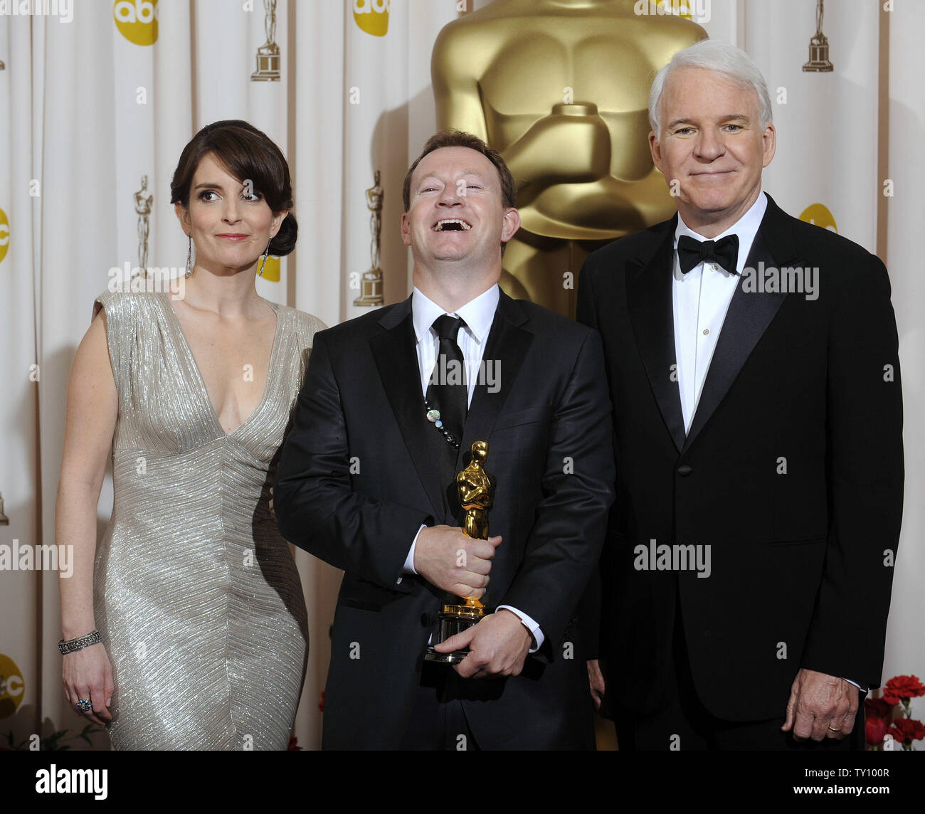 Simon Beaufoy, flanked by Tina Fey and Steve Martin, stands with his ...