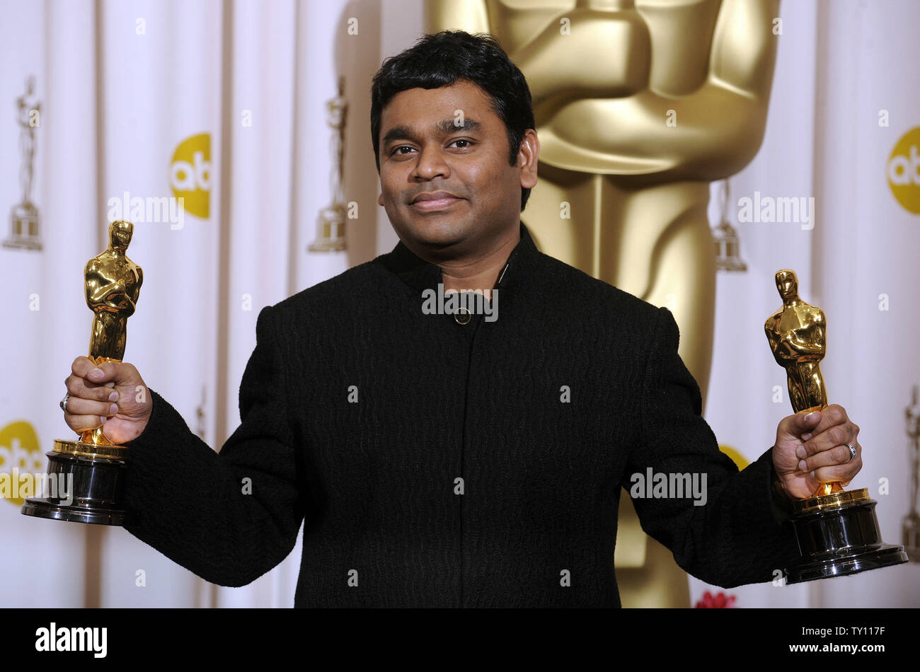Composer A.R. Rahman holds his Oscars for achievement in music for both ...