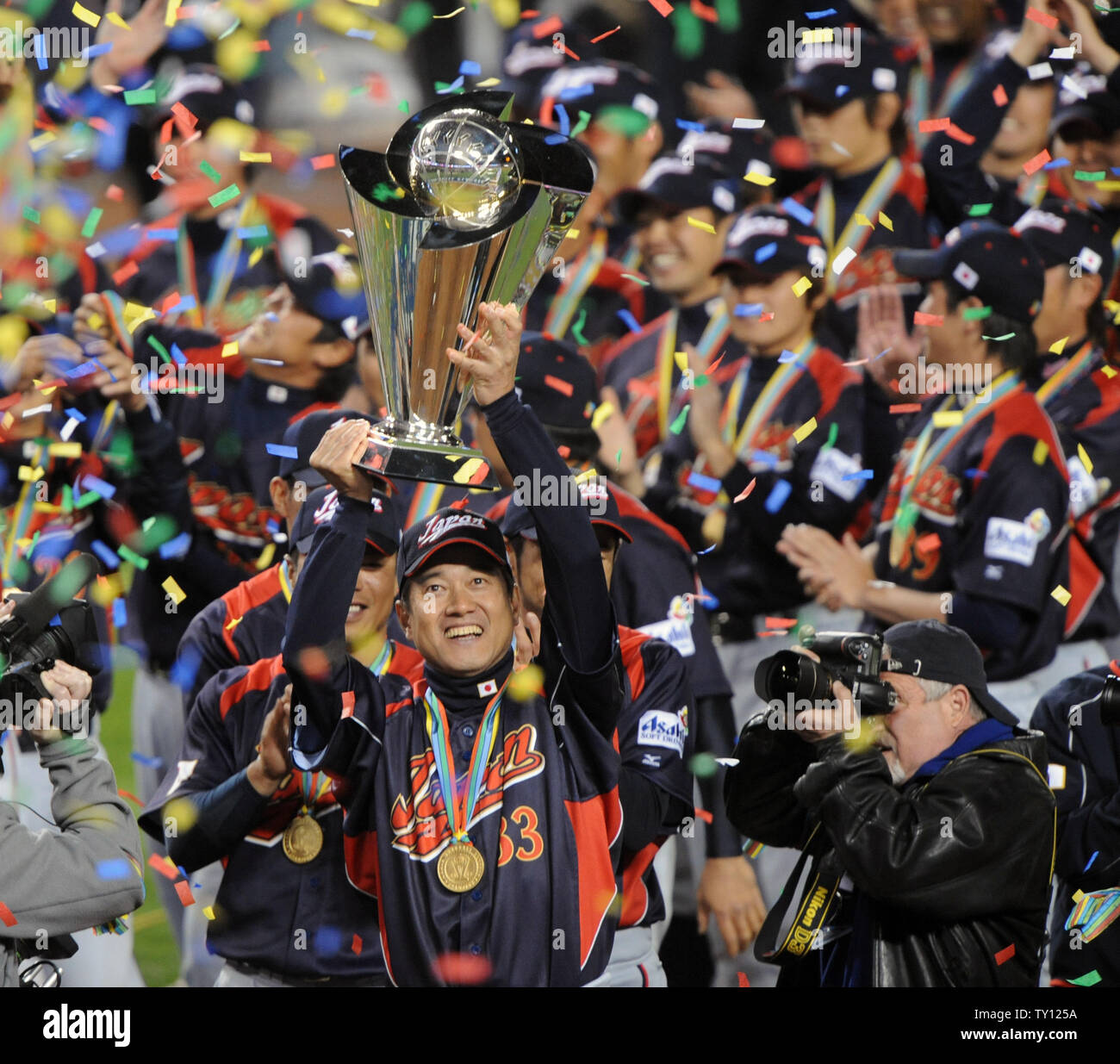 Team Japan's manager Tatsunori Hara hoists the trophy after defeating ...