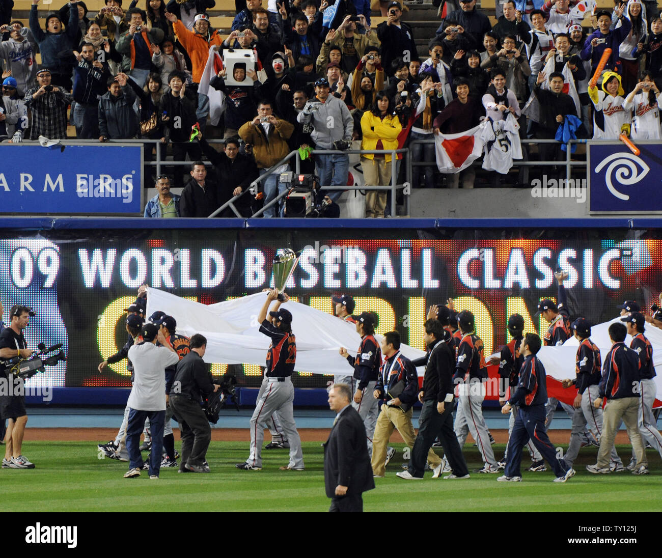 Team Japan's J.J. Putz holds up the trophy as the team celebrates ...