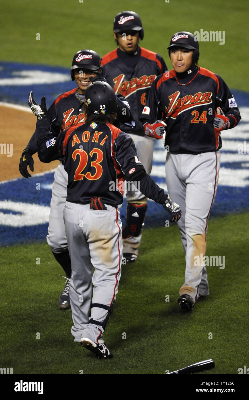 Japan's Akinori Iwamura (L) and Seiichi Uchikawa (R) are congratulated ...