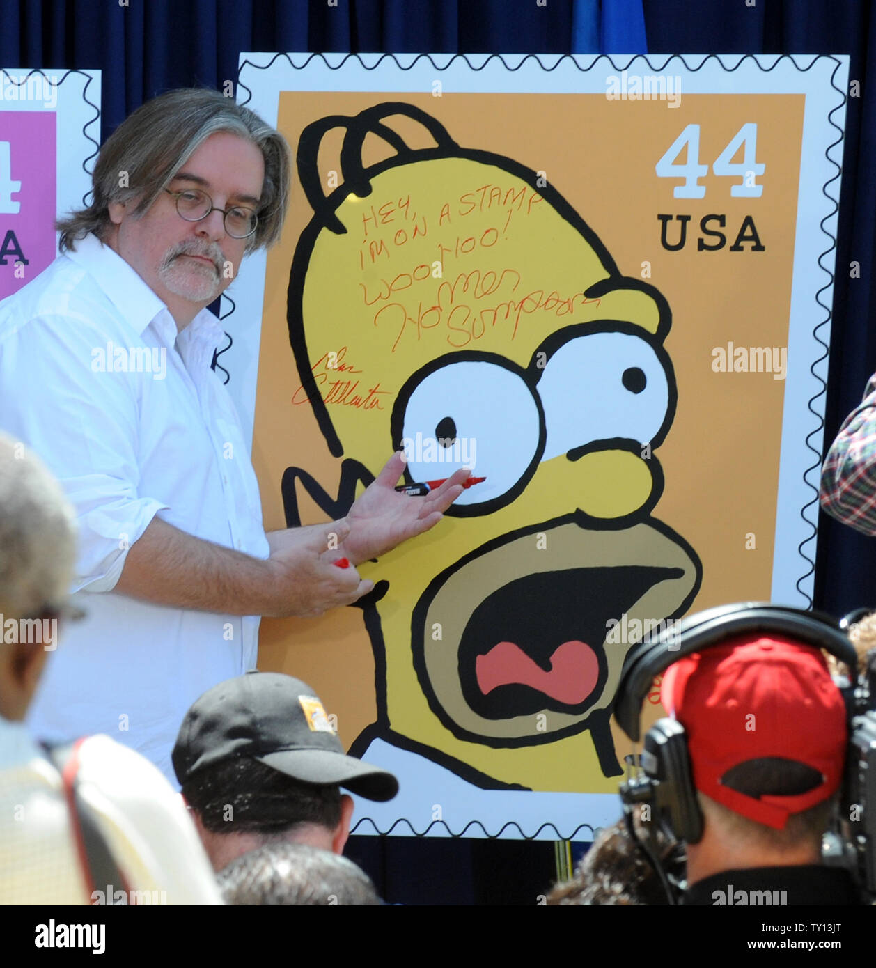 Creator and Executive Producer Matt Groening signs a poster at the ...