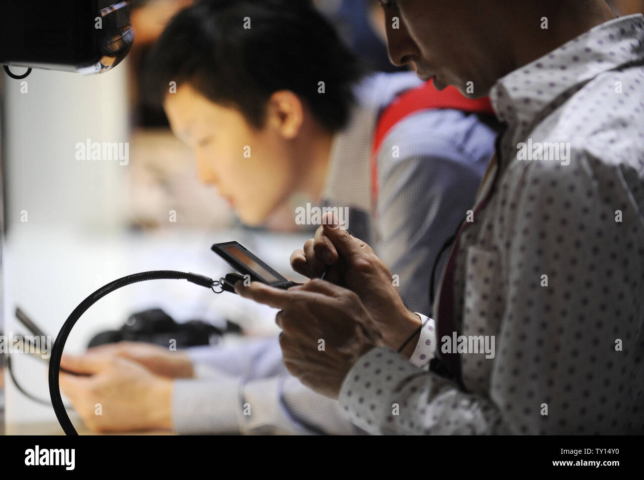 Attendees play Nintendo DS units during the E3 Electronic Entertainment ...