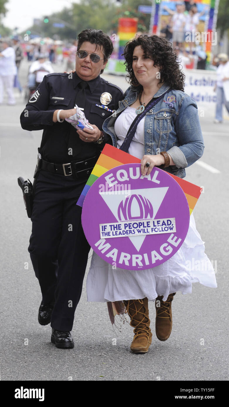 Participants carry signs and pass out candy during the 2009 LA Pride ...