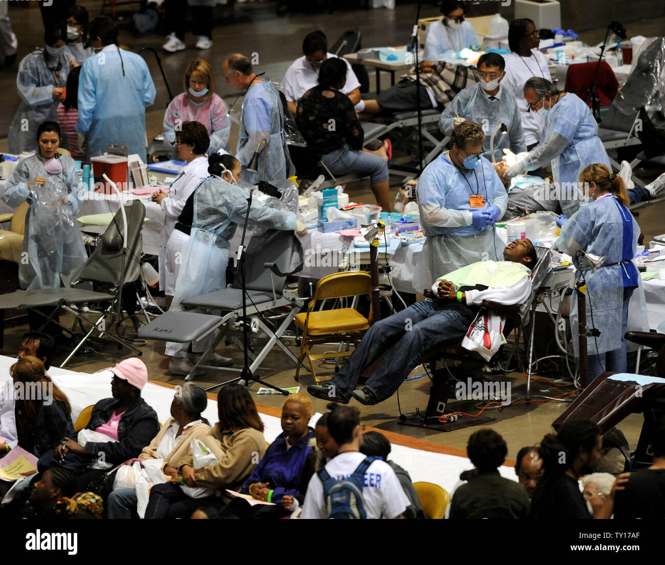Patients receive dental care, assembly-line style, at a large health ...