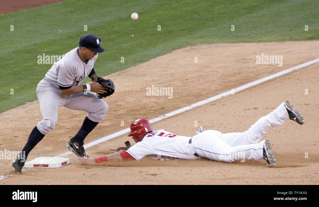 Los Angeles Angels' Jeff Mathis is safe at third base on a bunt by Los ...