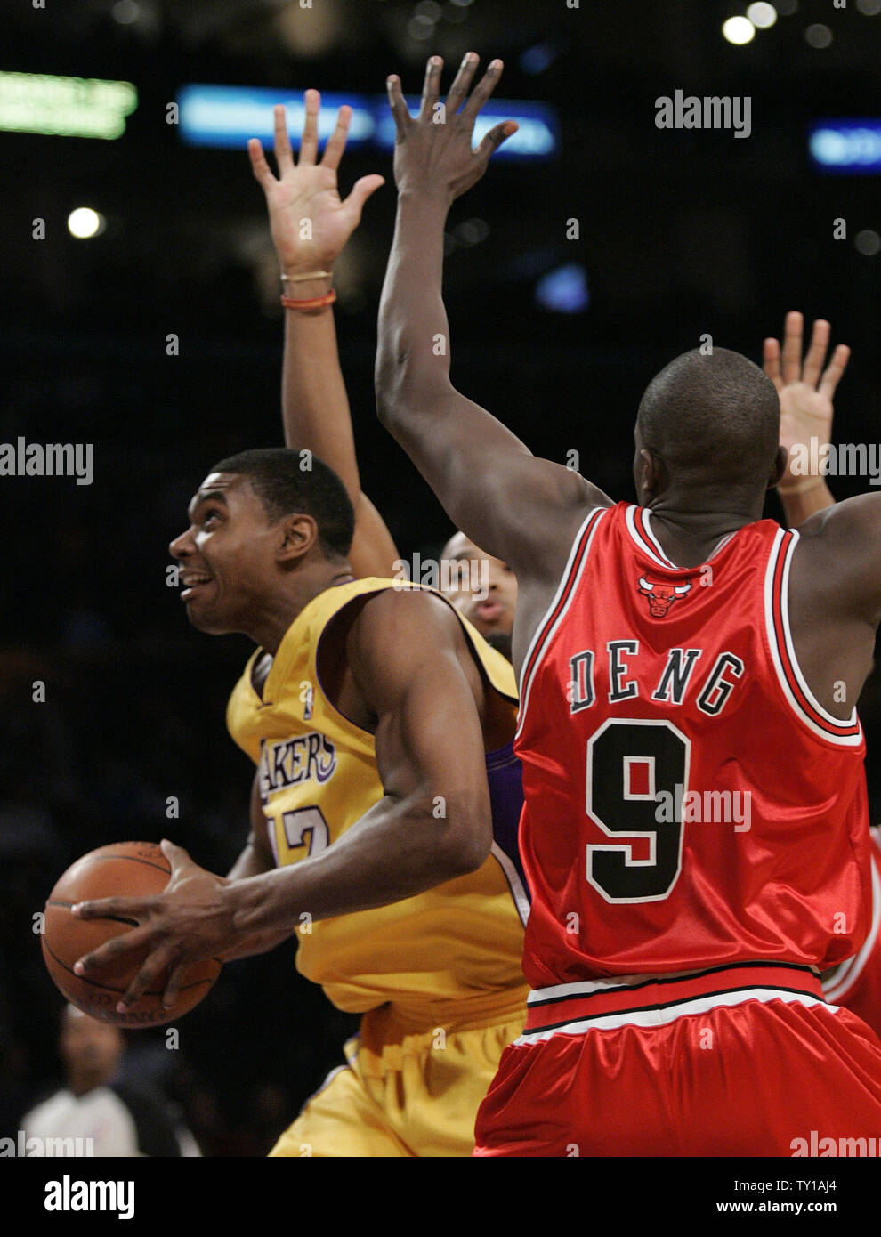 Los Angeles Lakers center Andrew Bynum, left, goes up for a basket past ...