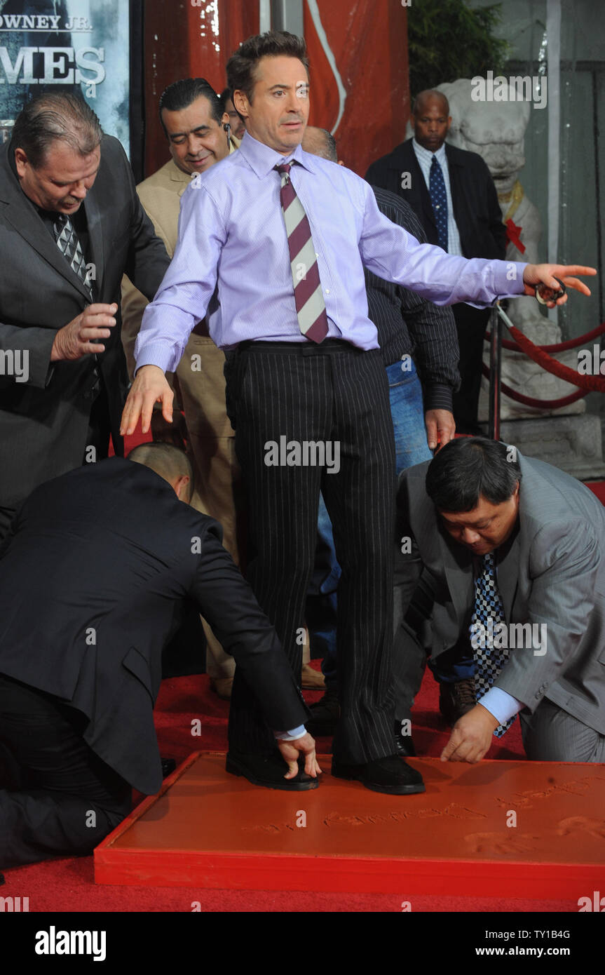 Actor Robert Downey Jr. tries to maintain his balance as he places his ...