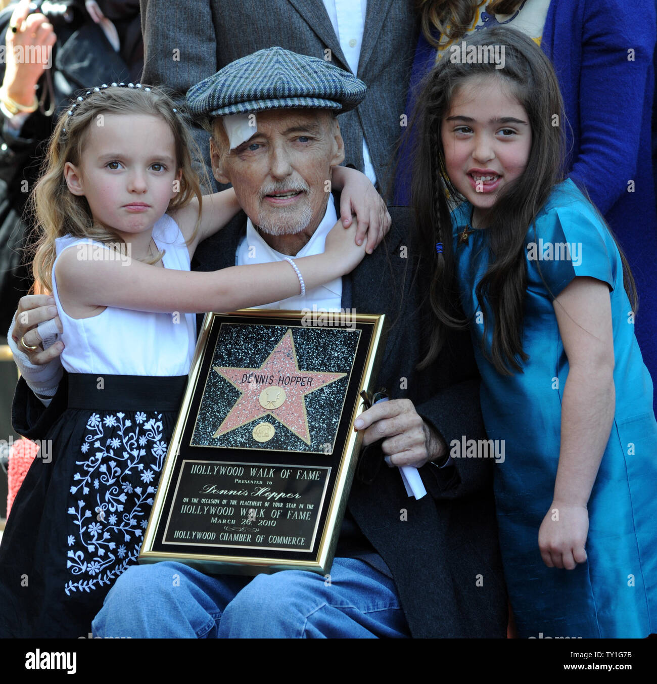 Actor Dennis Hopper is hugged by his daughter Galen (L) and his ...