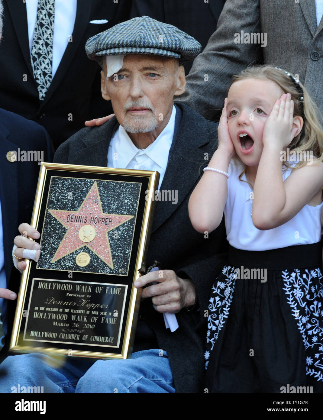 Actor Dennis Hopper looks on as his daughter Galen reacts during a ...