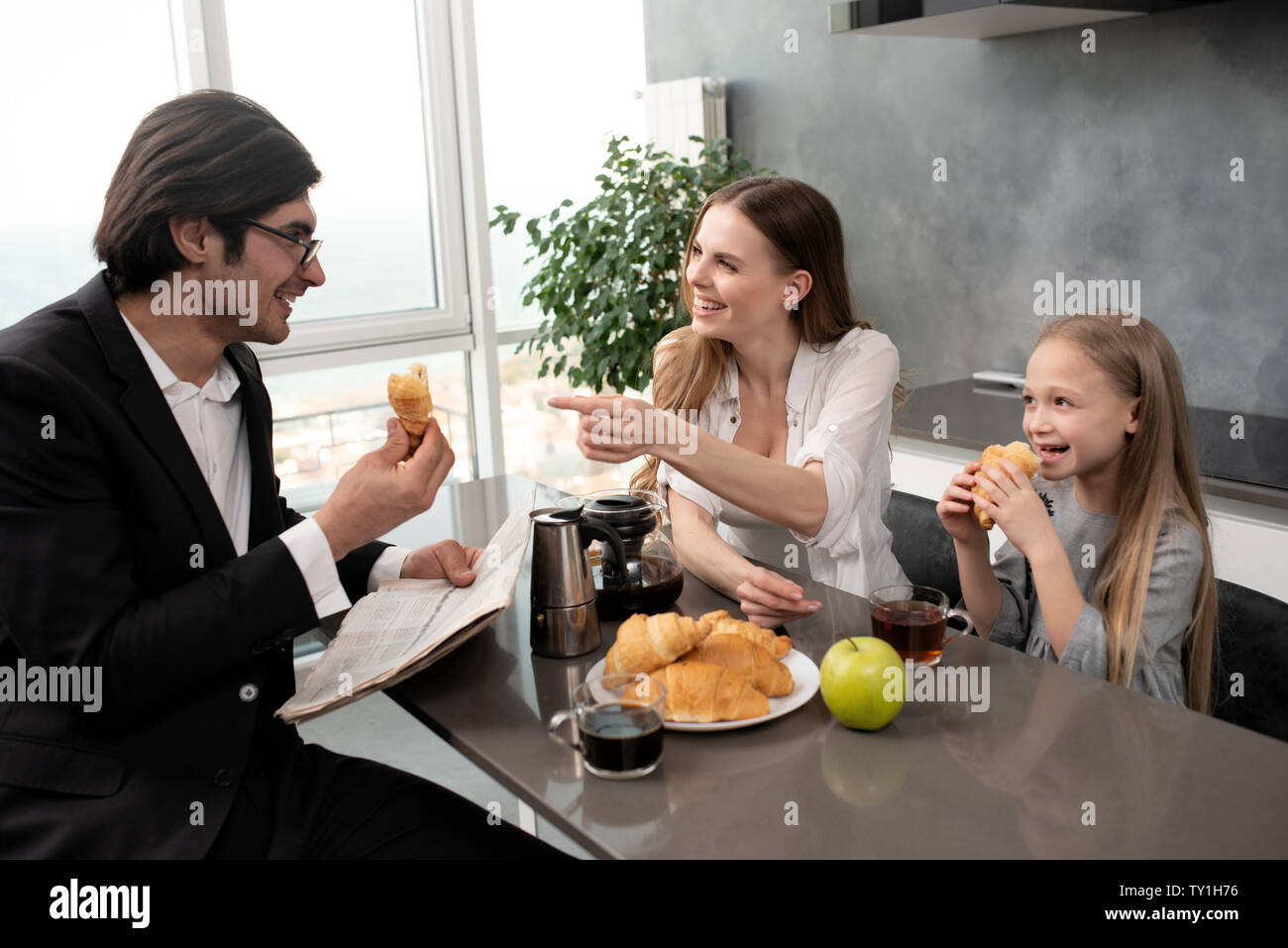Happy family have a breakfast at home Stock Photo - Alamy